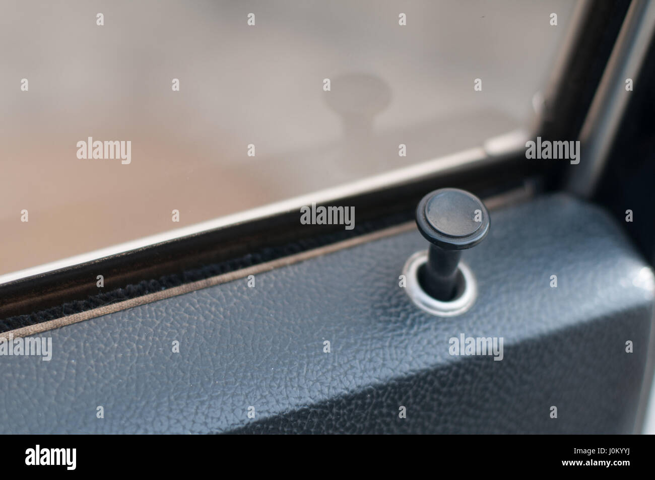 Lock Button in old car black color near window Stock Photo - Alamy