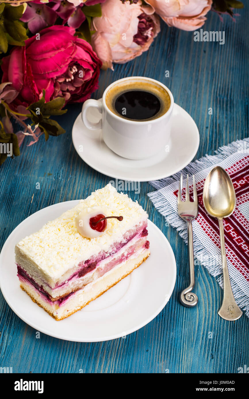 Piece of cake, sponge cakes, cream, cherries, whipped cream on blue ...