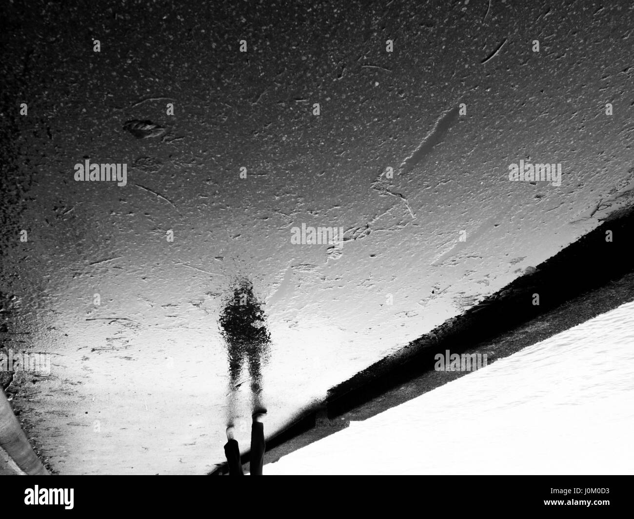 Reflection of people walking along street in the rain Stock Photo - Alamy