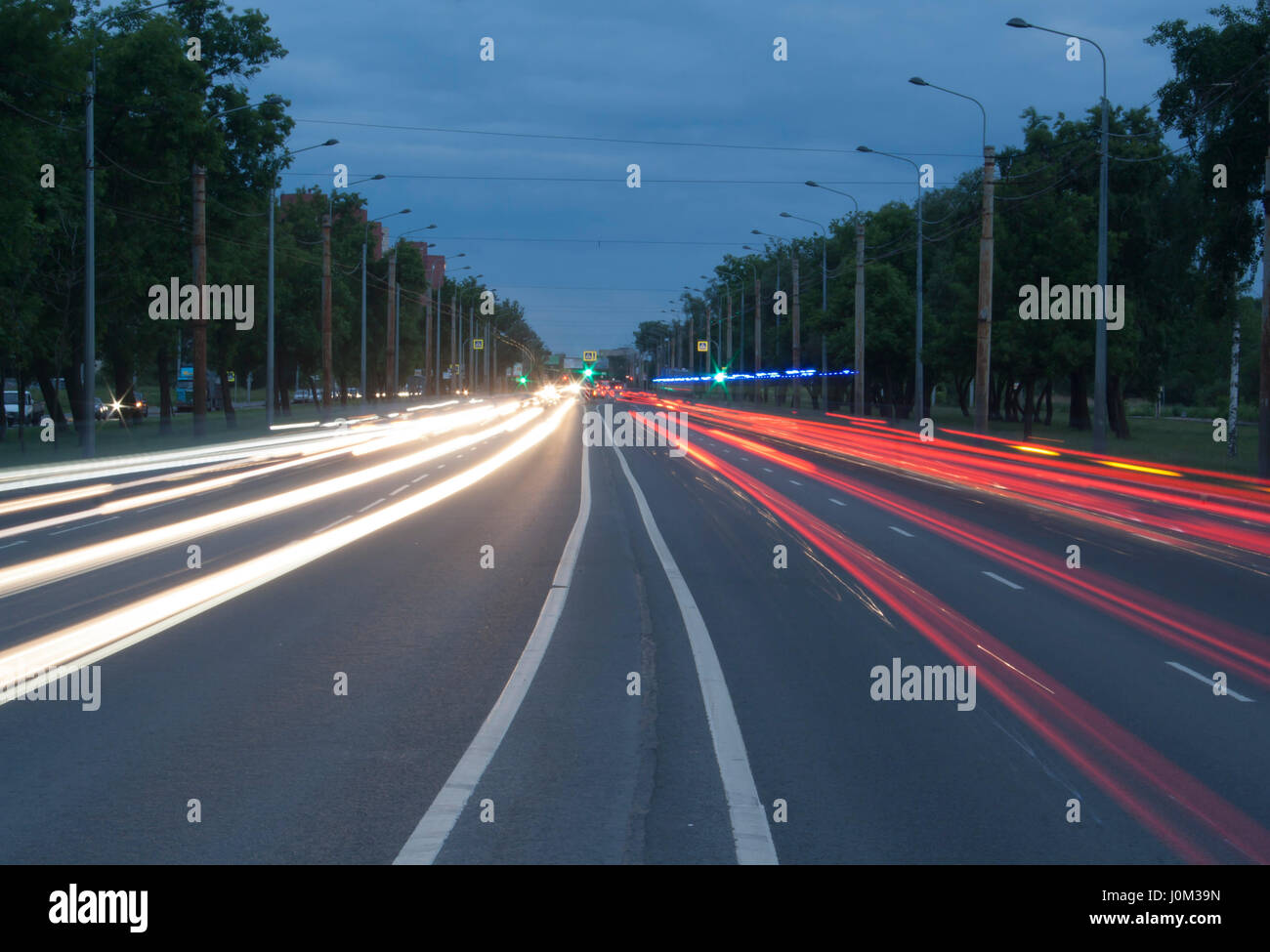 City road with traffic at night Stock Photo - Alamy