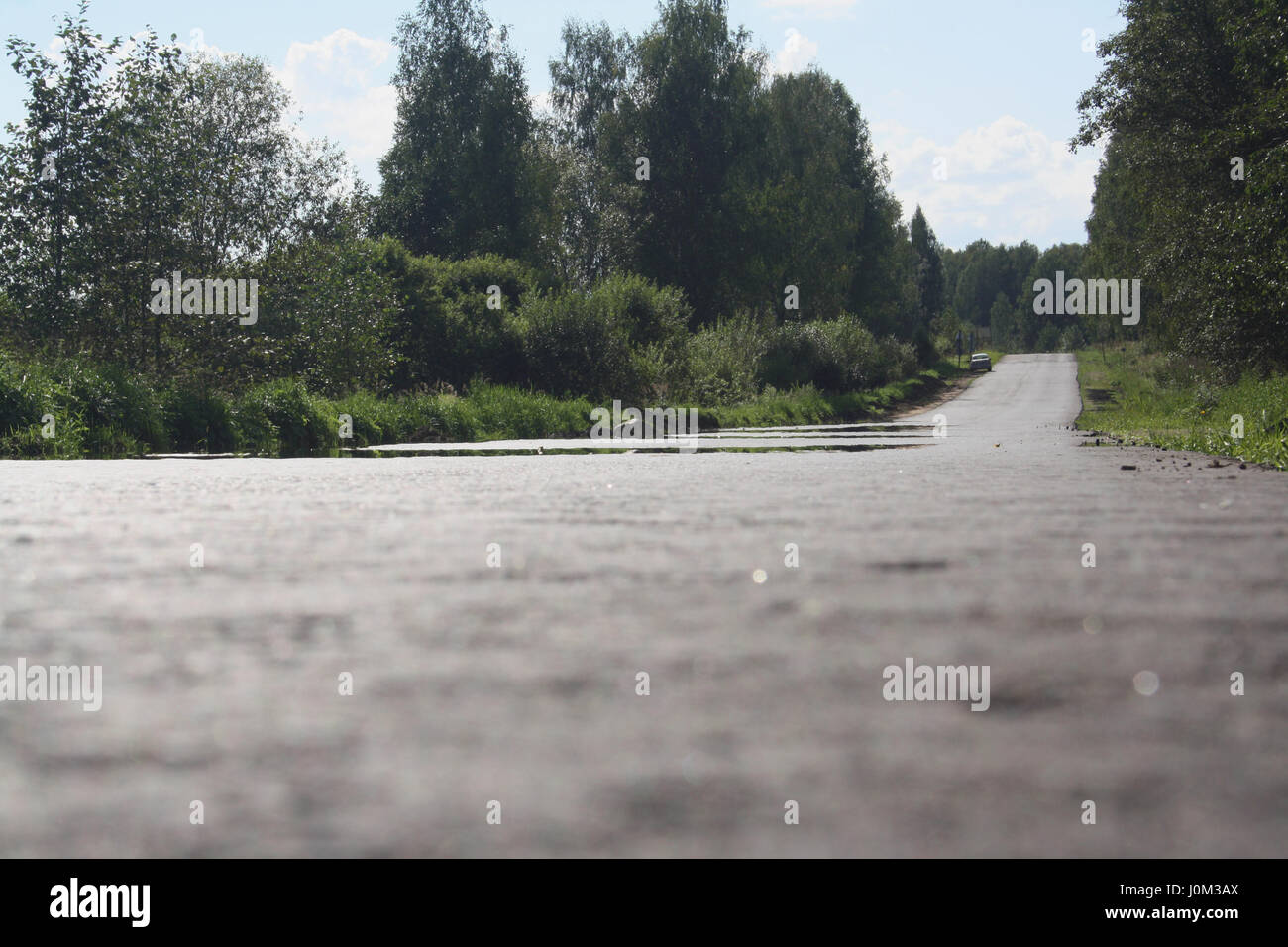 puddle on the road mirage Stock Photo - Alamy