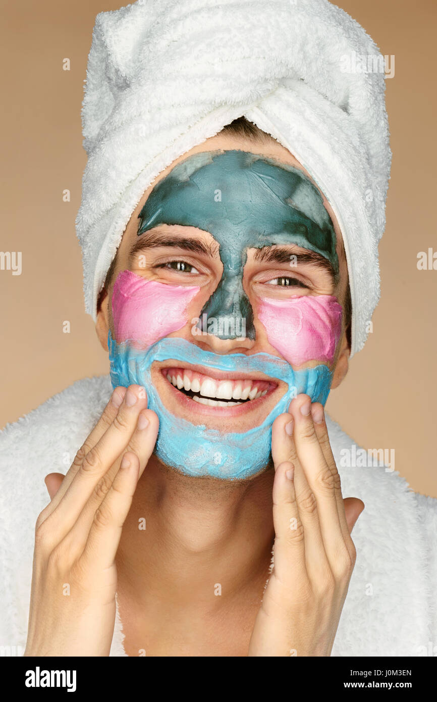Happy man applying three different face masks on face. Photo of man ...