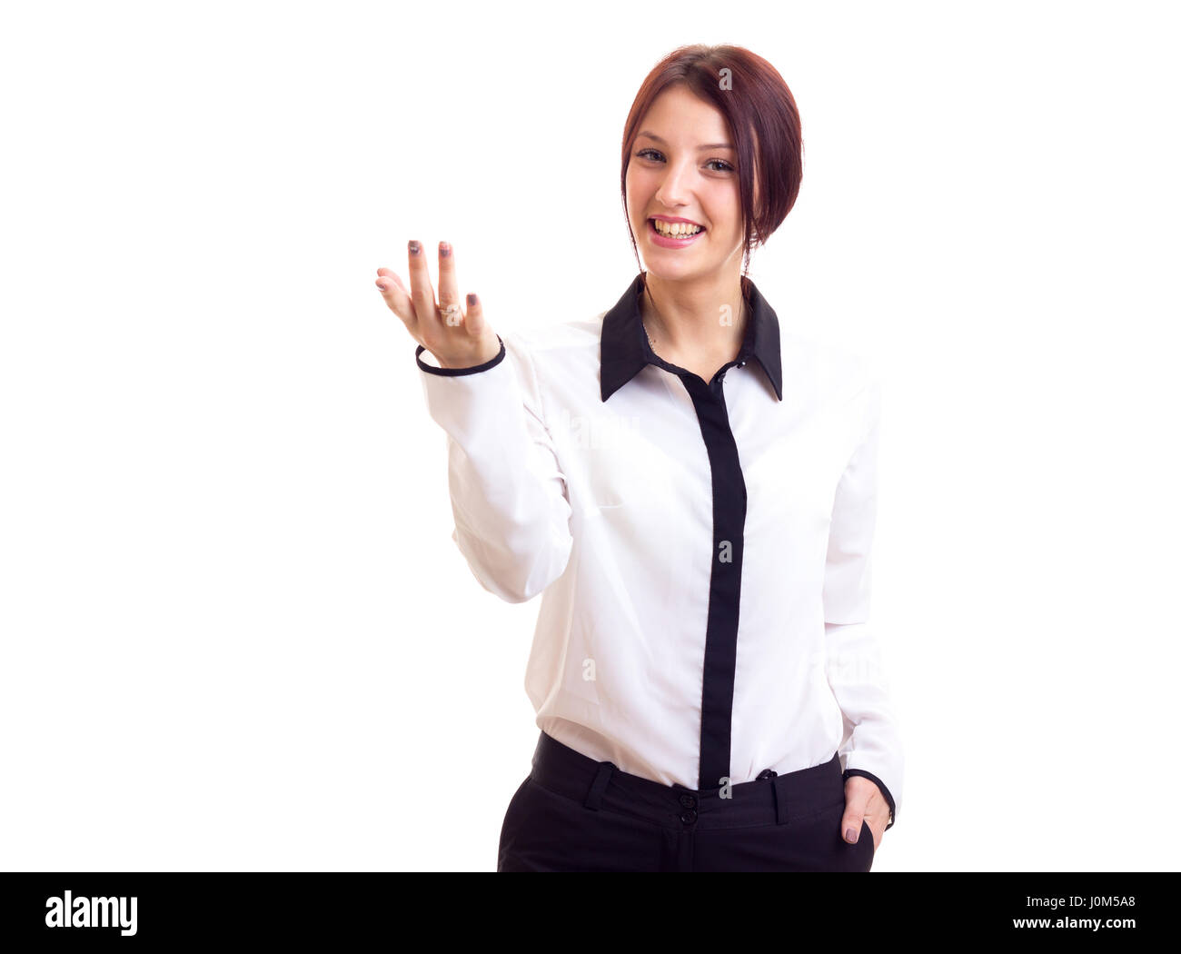Young optimistic woman in white shirt and black trousers with ponytail ...