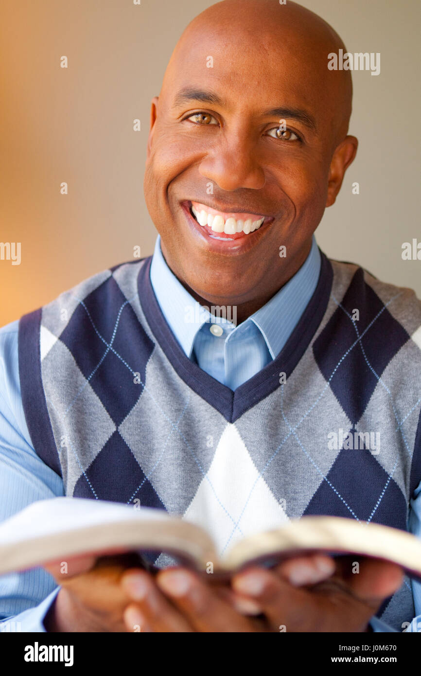 African American man reading the Bible at home Stock Photo - Alamy