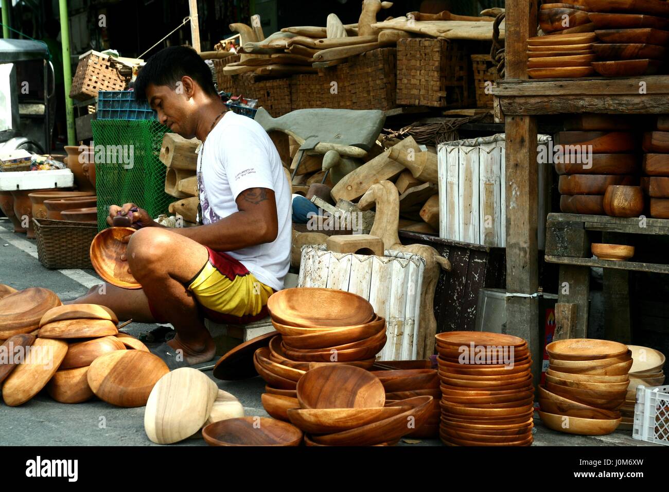 QUEZON CITY, PHILIPPINES - JUNE 22, 2015: A handicraft maker apply ...