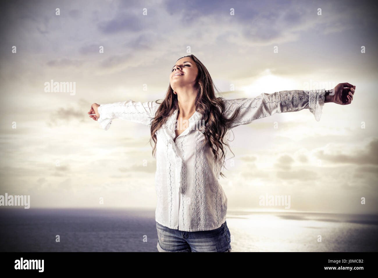 Brunette woman feeling free outside Stock Photo - Alamy