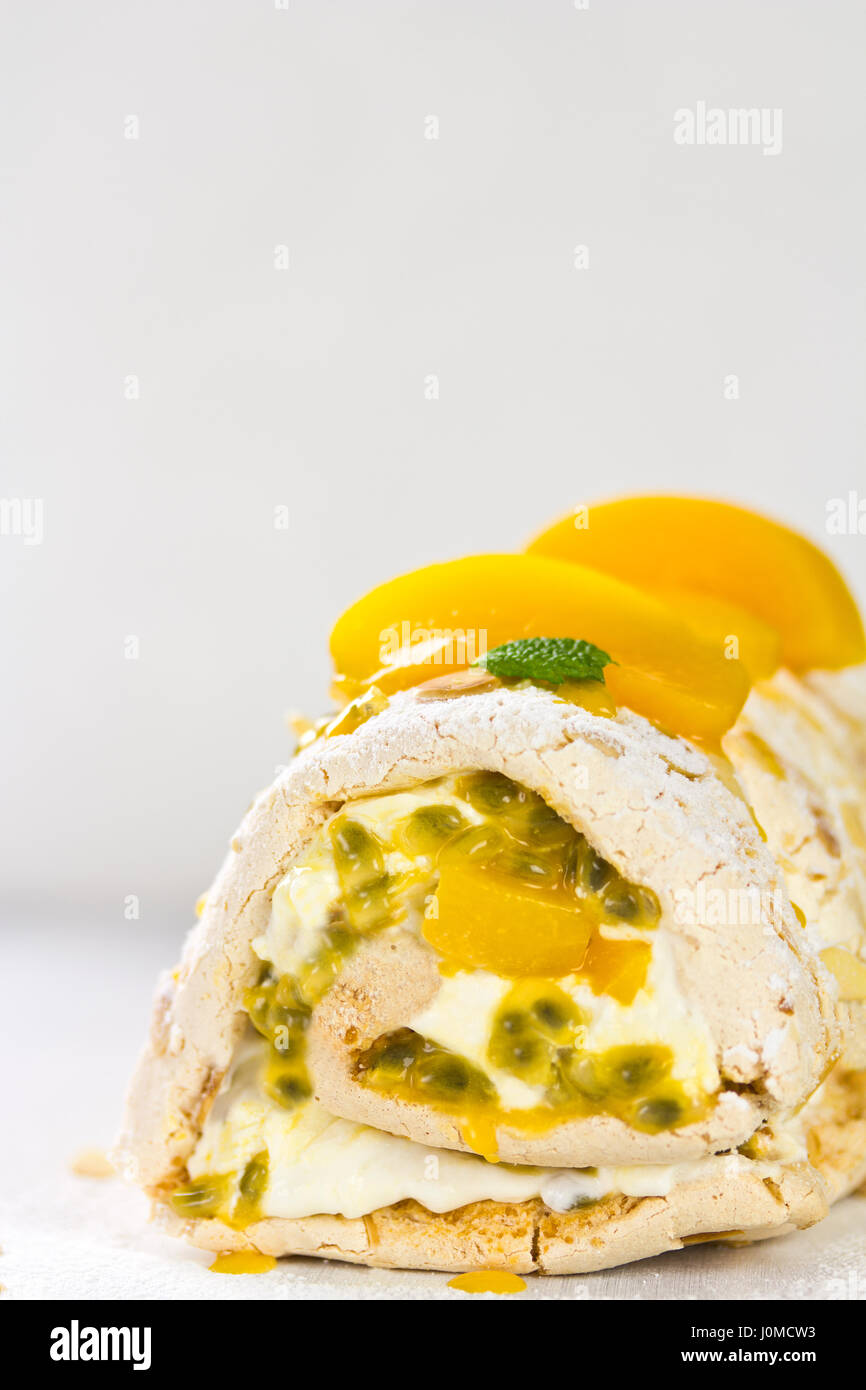 Meringue roulade with cream and passion fruit Stock Photo - Alamy
