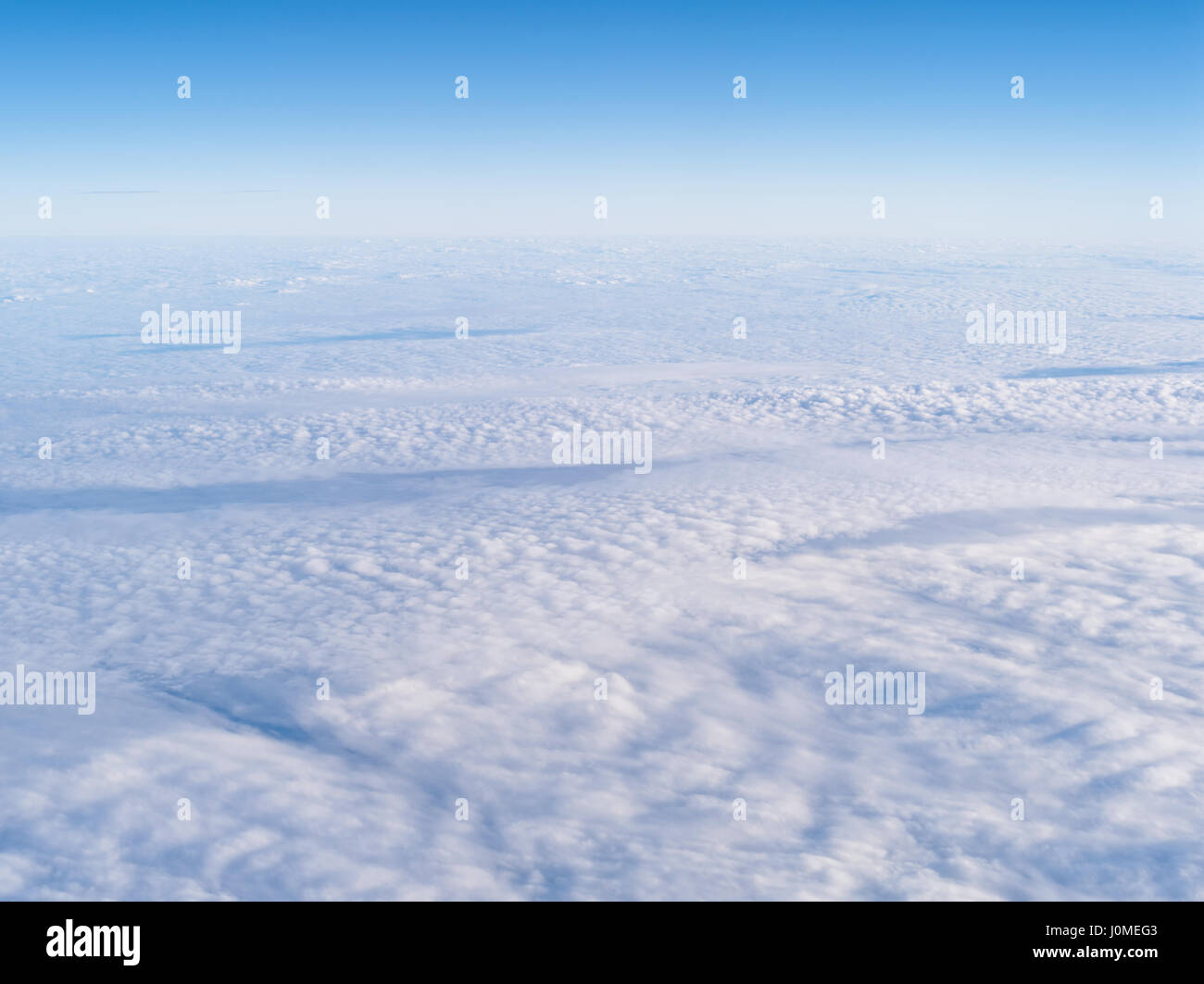 clouds. view from the window of an airplane flying above the clouds ...