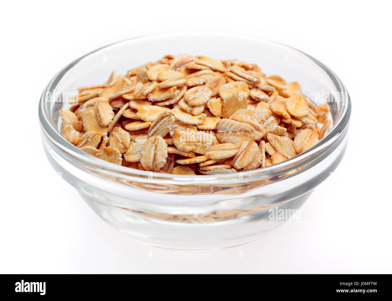 Wheat flakes in glass bowl on white background Stock Photo - Alamy