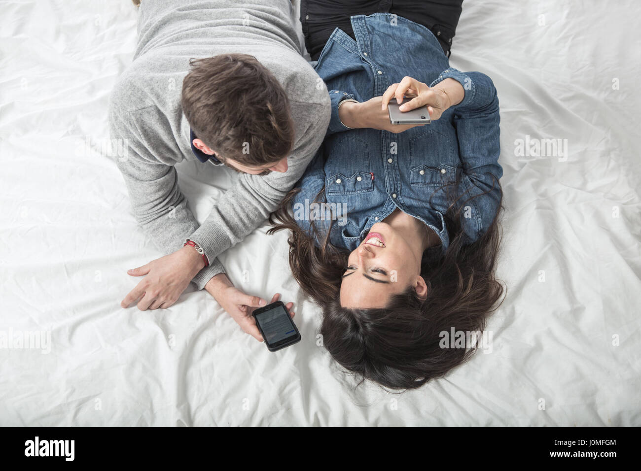 Young couple with tech Stock Photo - Alamy