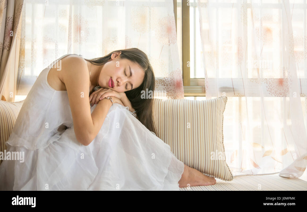 Girl relaxing by the bay window at home Stock Photo - Alamy