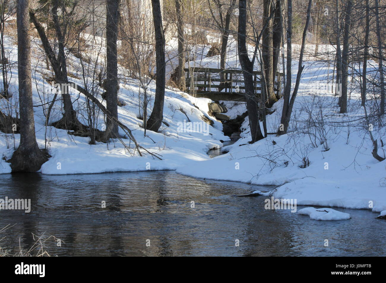 Little wooden walk bridge spanning a deep crevice full of rocks, water ...