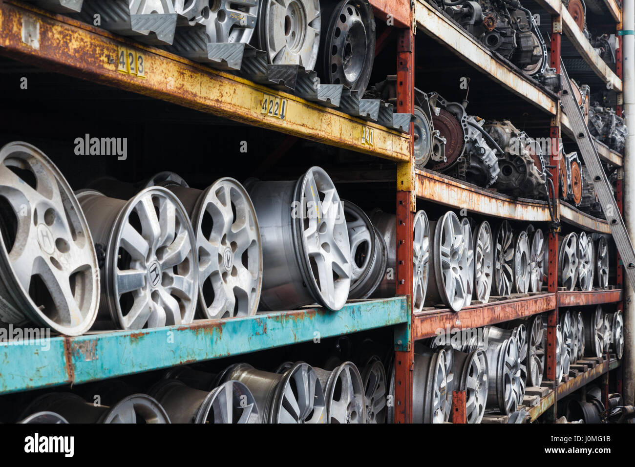 Wheel rims and car transmissions on shelves for resale Stock Photo - Alamy