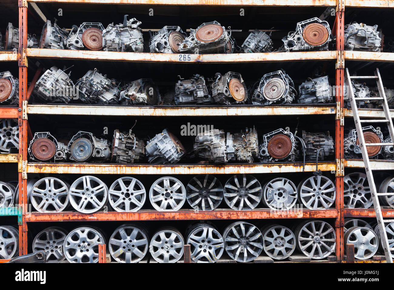 Wheel rims and car transmissions on shelves for resale Stock Photo - Alamy