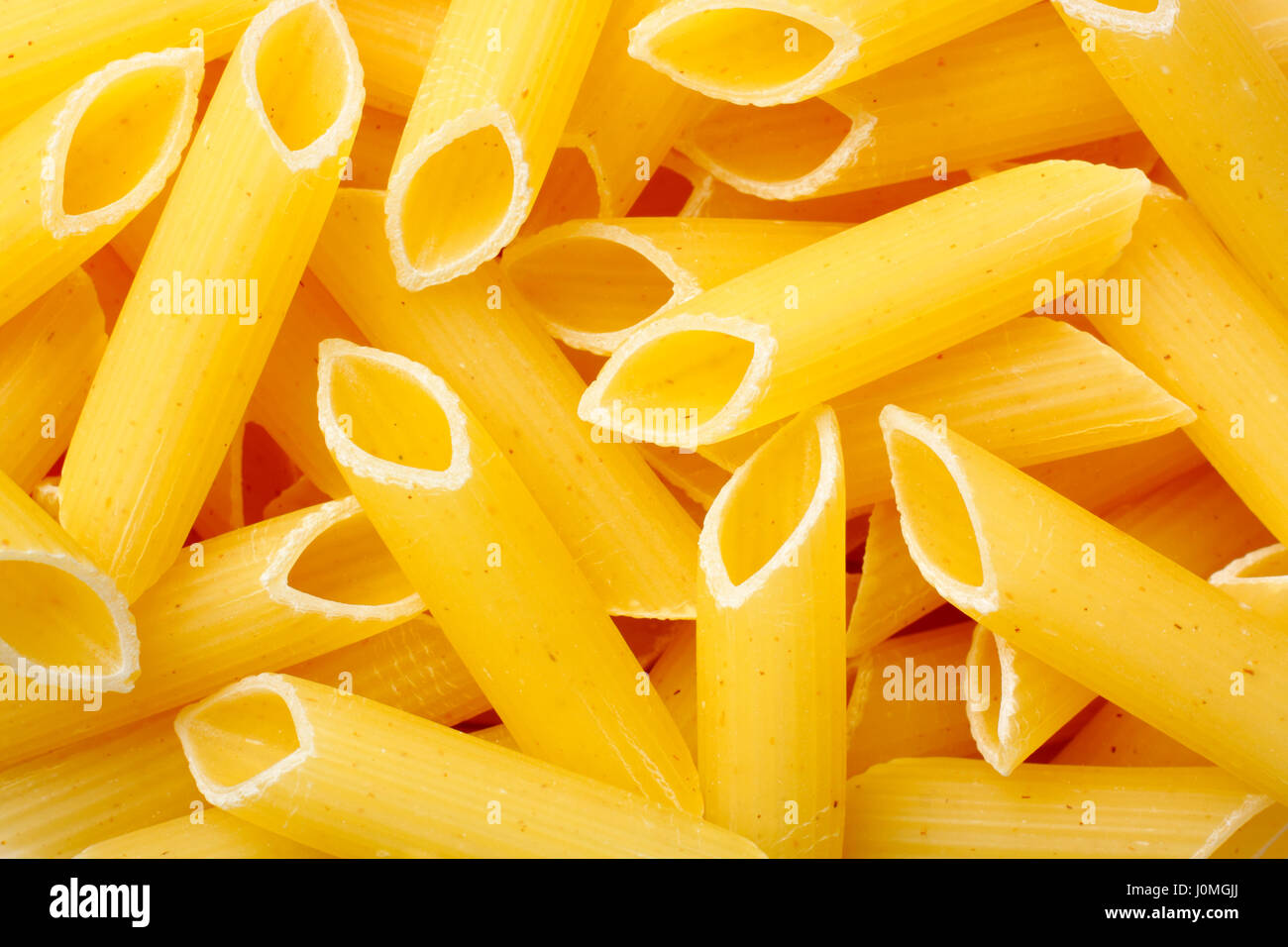Raw penne rigate pasta. Full frame, top view Stock Photo - Alamy