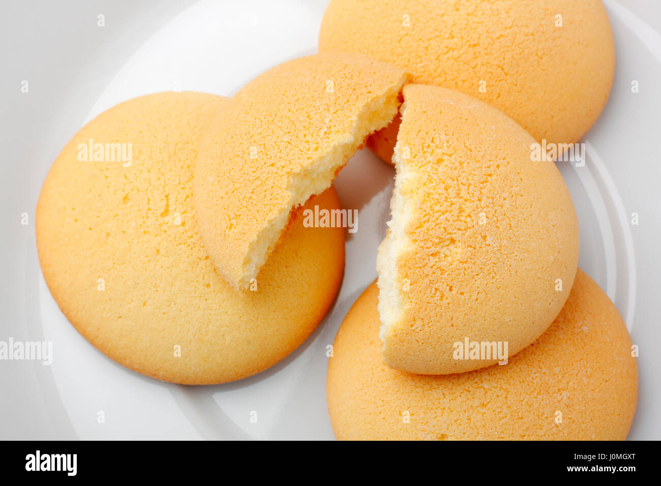 Sponge cakes from above with one cake broken Stock Photo - Alamy