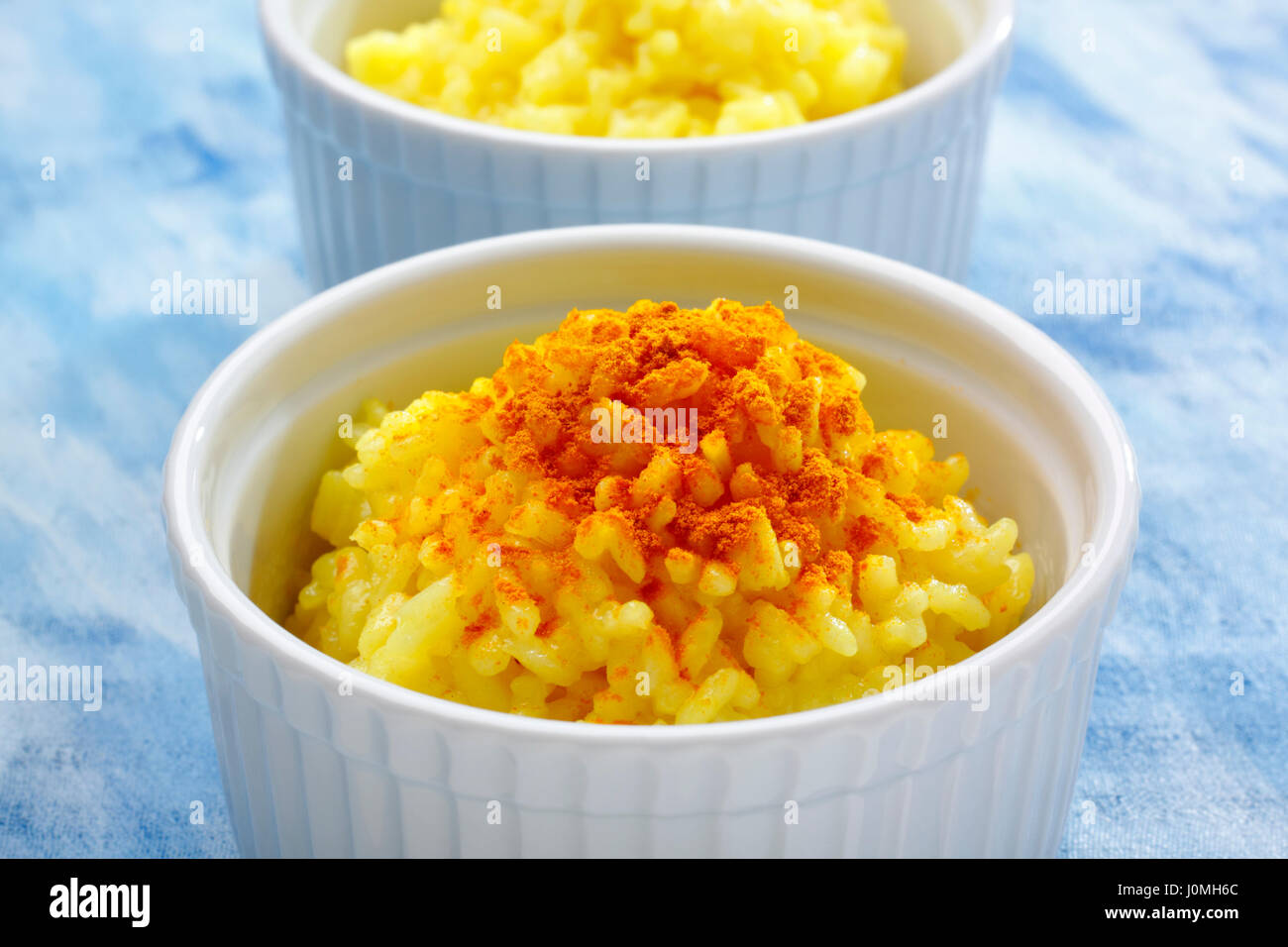 Ramekins filled by white long grain rice (boiled with curcuma) and ...