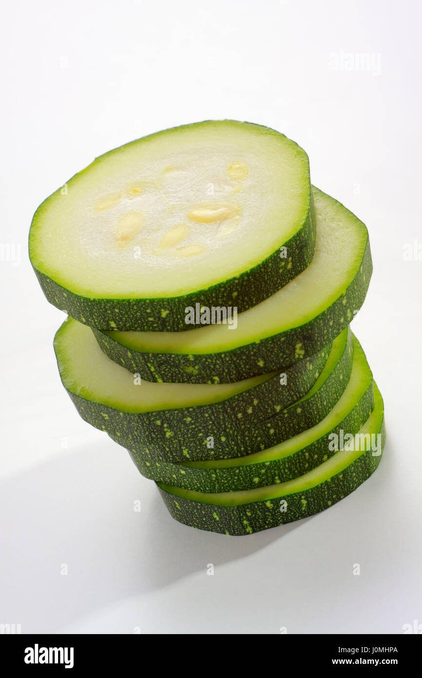 Pile of sliced courgette on light background Stock Photo - Alamy