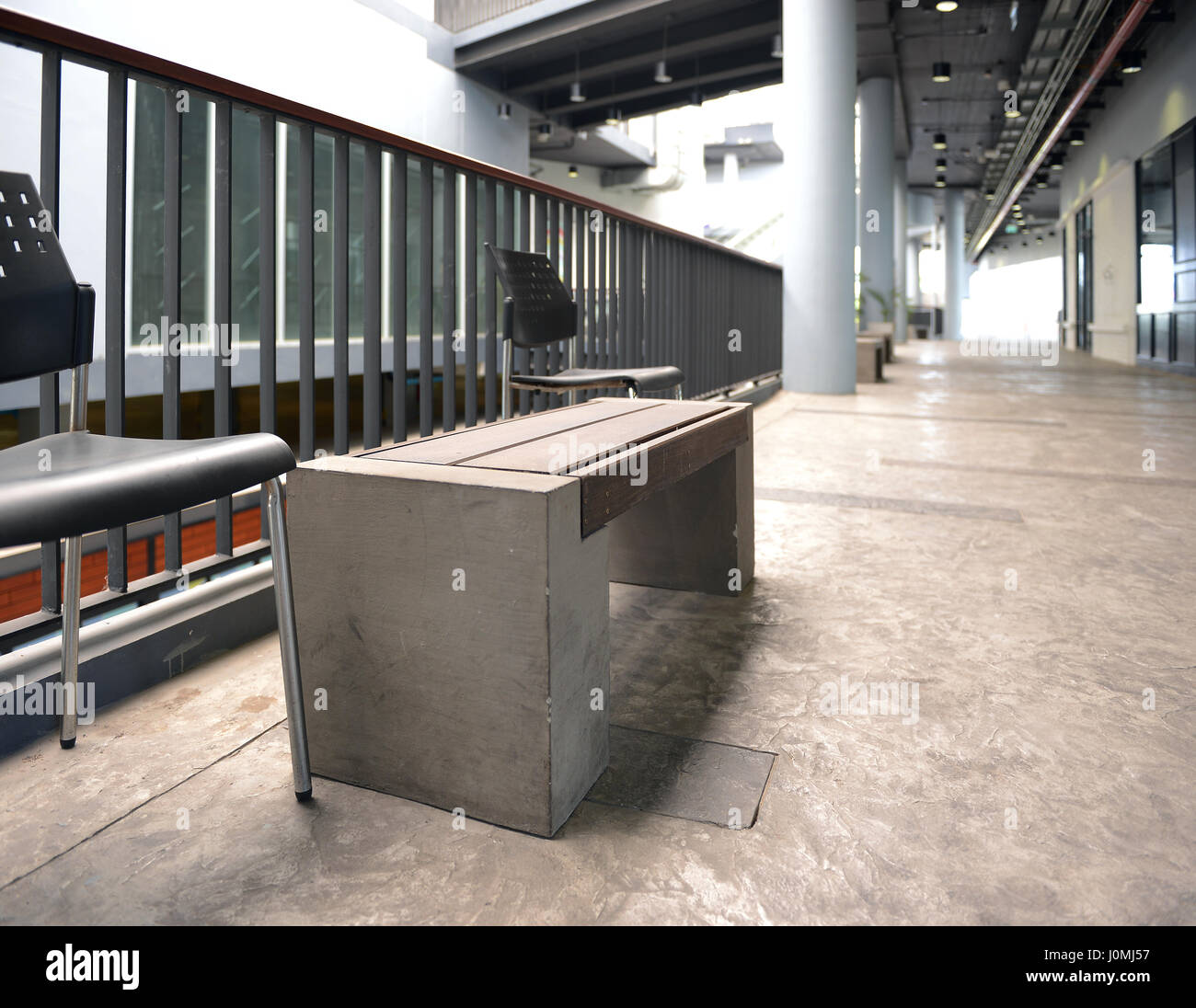 Modern Bench in a shopping center, wooden concrete Stock Photo - Alamy