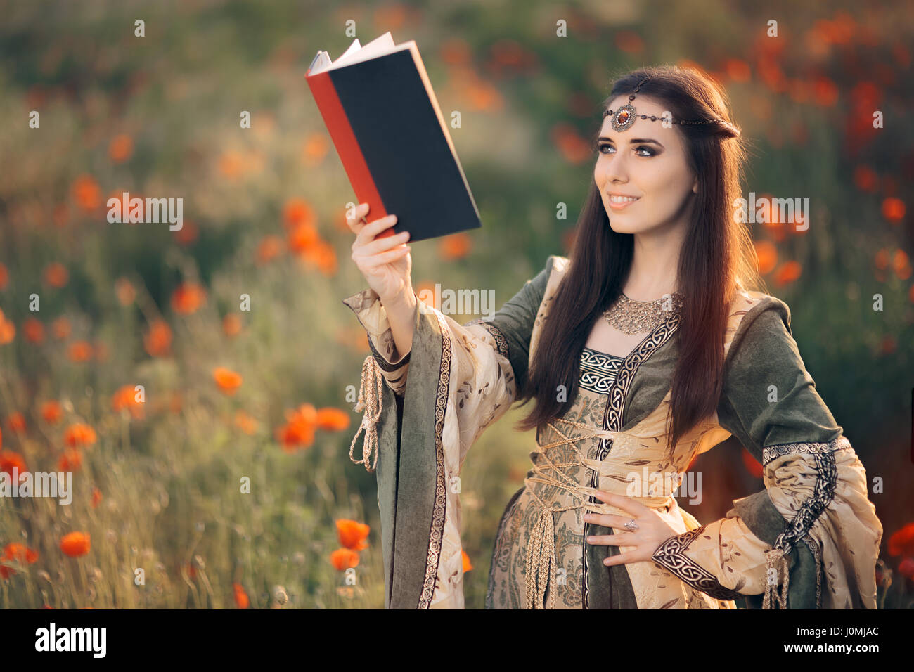 Medieval Reading a Book in a Magical Field of Poppies Stock Photo - Alamy