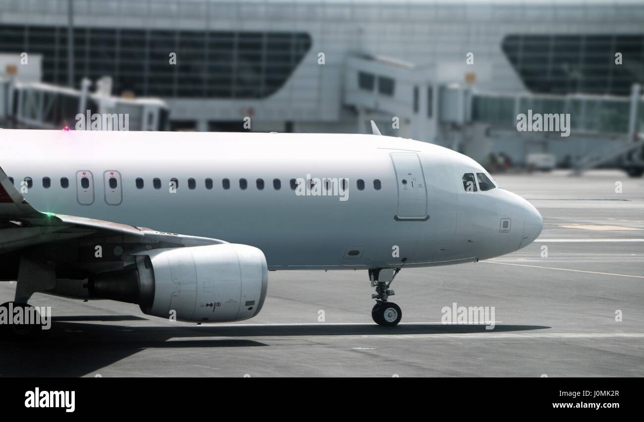 Airplane moving on the ground from side view Stock Photo - Alamy