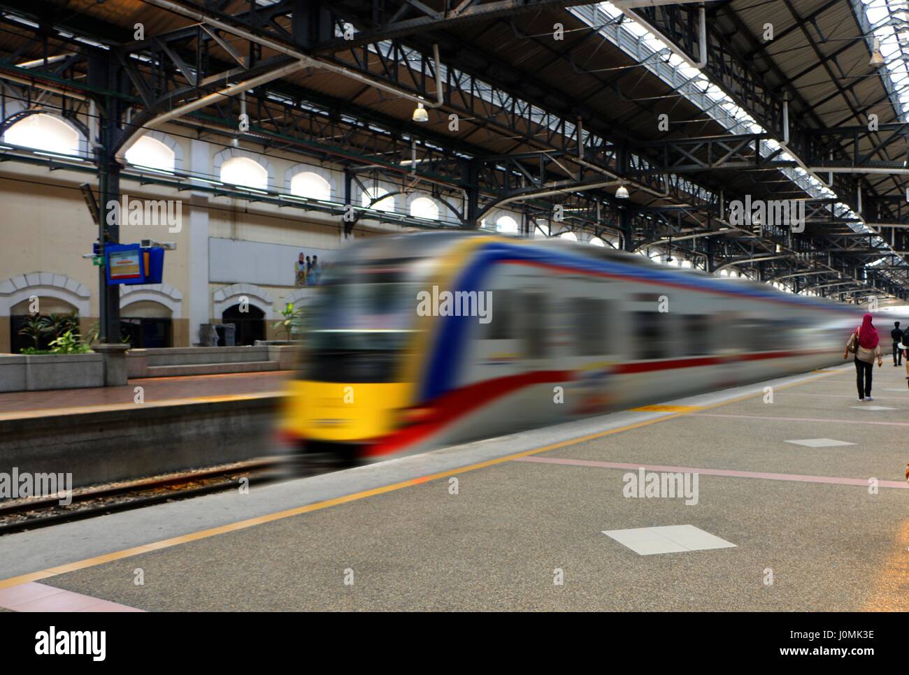 Fast moving train leaving station platform Stock Photo - Alamy