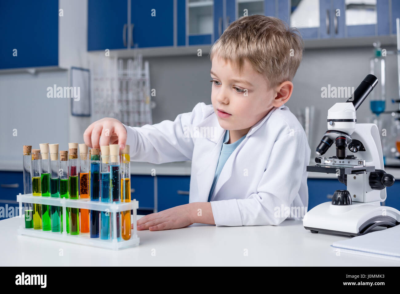 Little boy in chemical laboratory choosing reagents in test tubes Stock ...