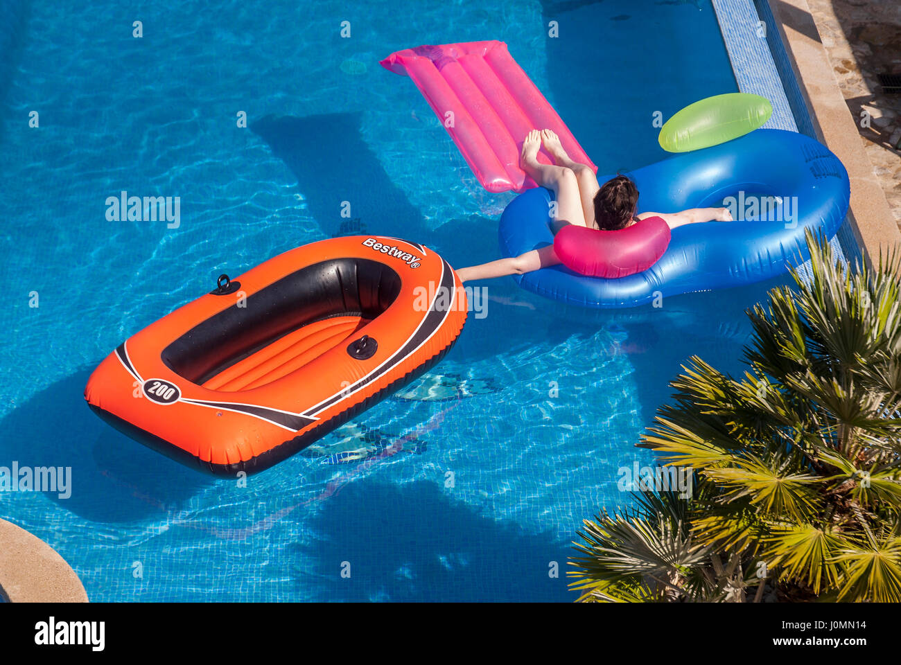 Girl n lilo swimming pool summer rubeer boat Stock Photo - Alamy