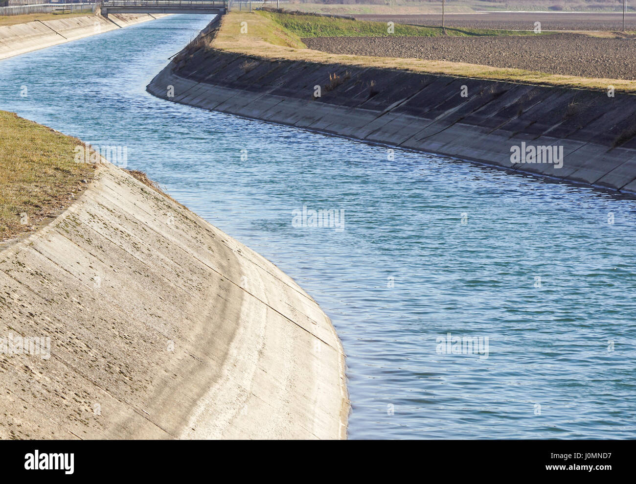 Irrigation canal between agricultural crops in italy Stock Photo - Alamy