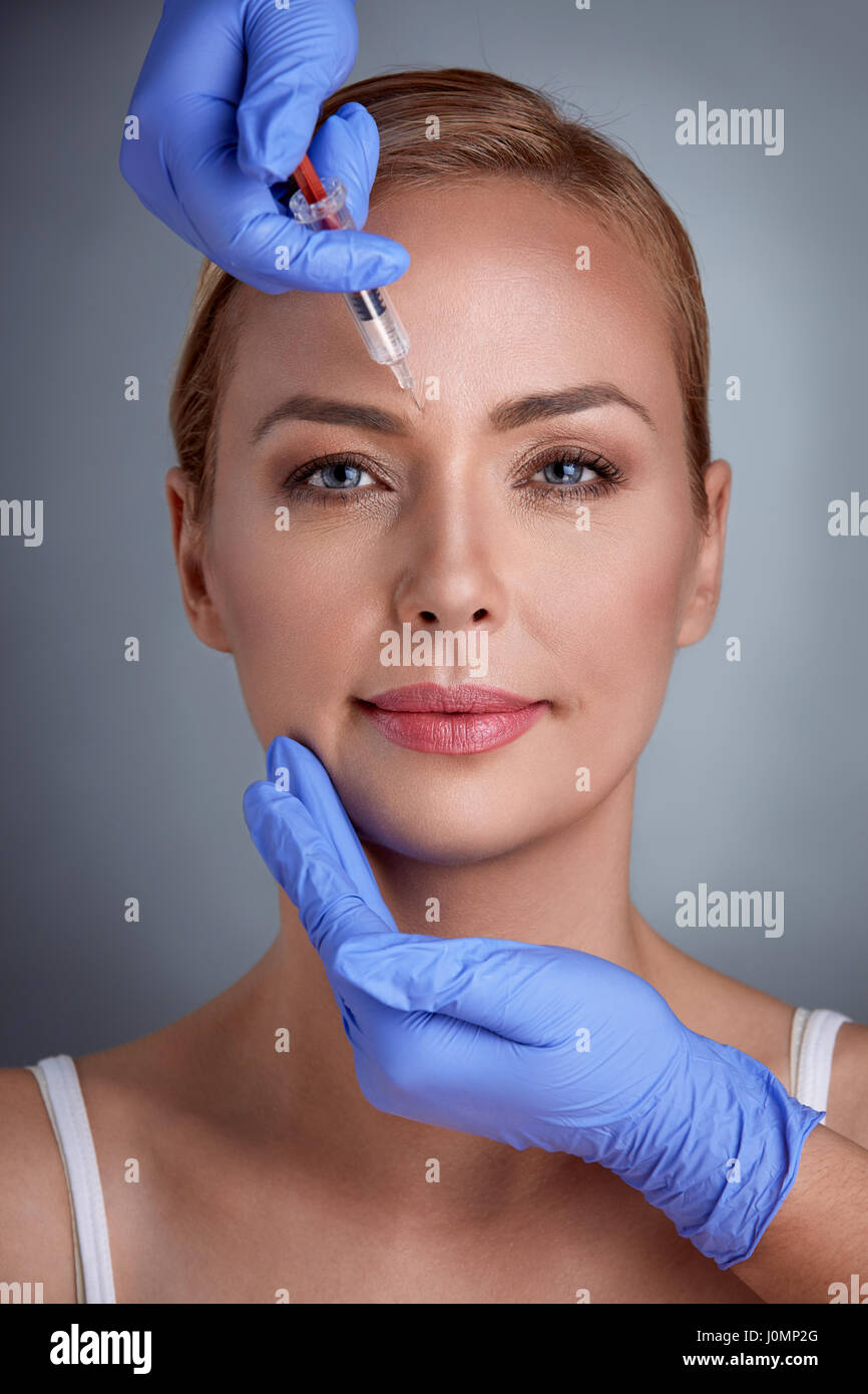 middle age receiving treatment of botox Stock Photo - Alamy