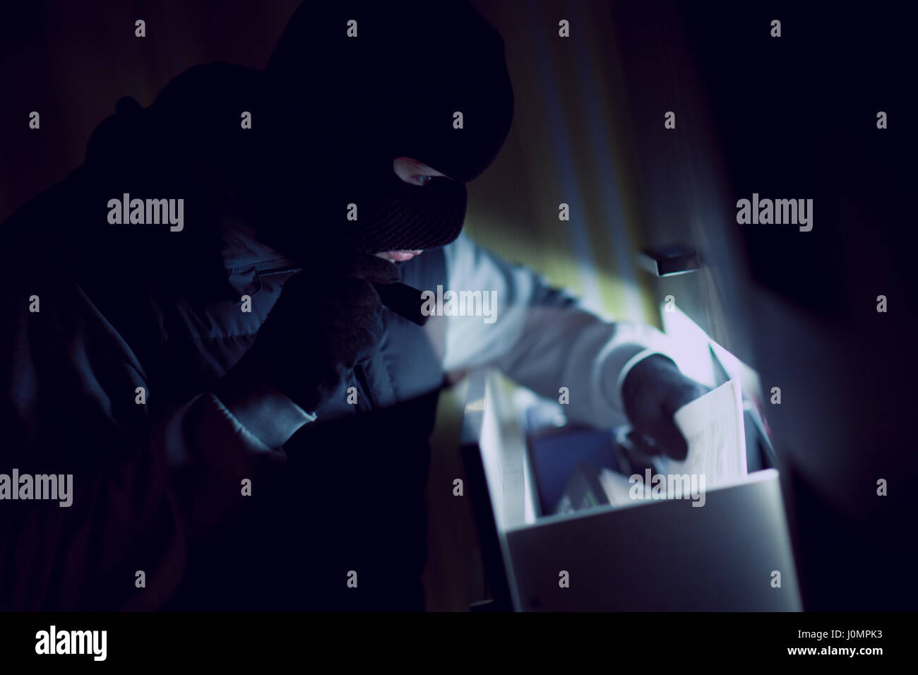 burglary man stealing documents Stock Photo - Alamy