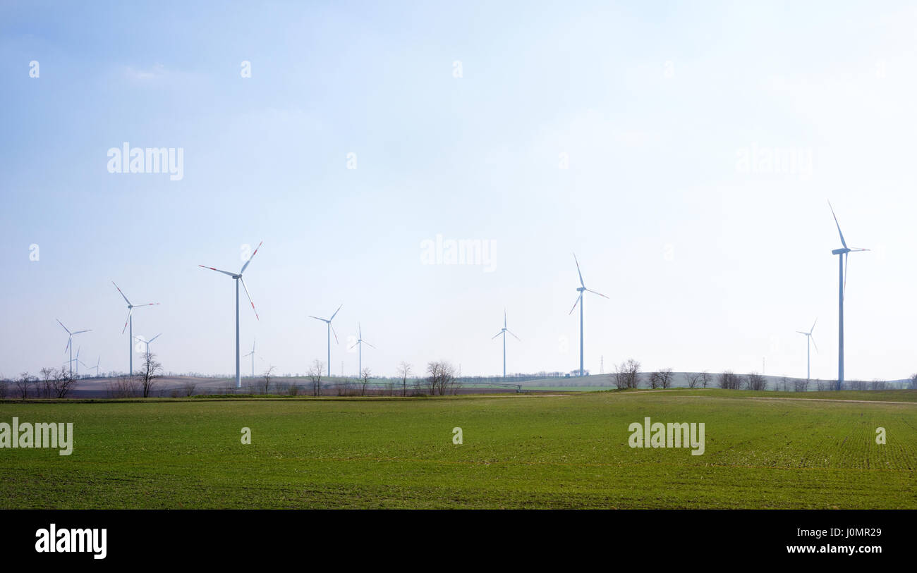 Power plant station with windmills on grass field Stock Photo - Alamy