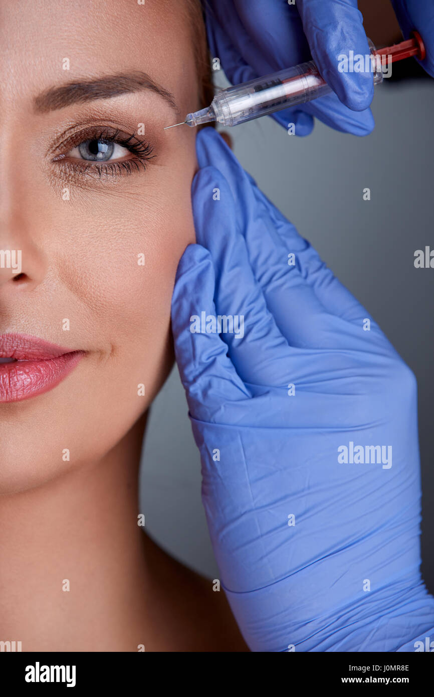 hands of expert beautician injecting botox ,woman have gently smiling ...