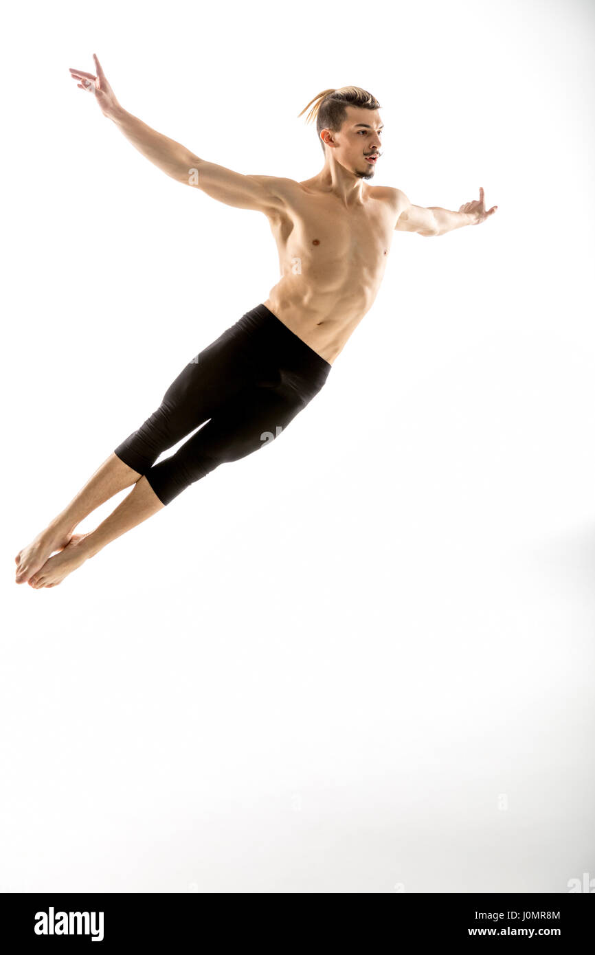 Young shirtless man contemporary dancer posing on white Stock Photo - Alamy