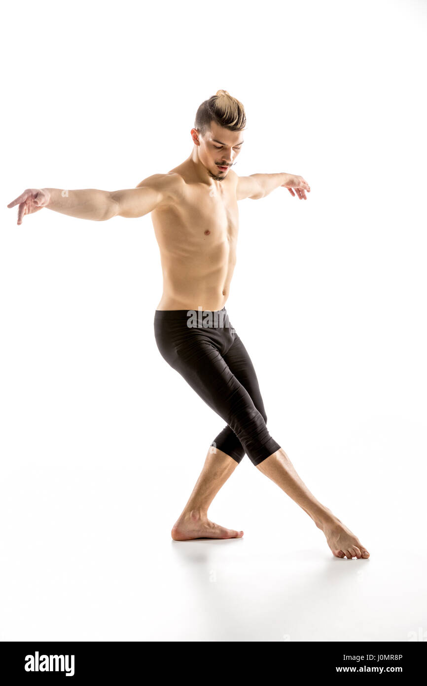 Young shirtless man performing contemporary dance position on white ...