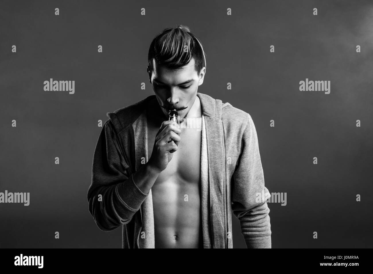 Black and white photo of young handsome man holding electronic ...