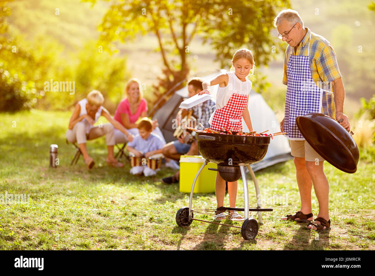 Happy family resting on grass hi-res stock photography and images - Alamy