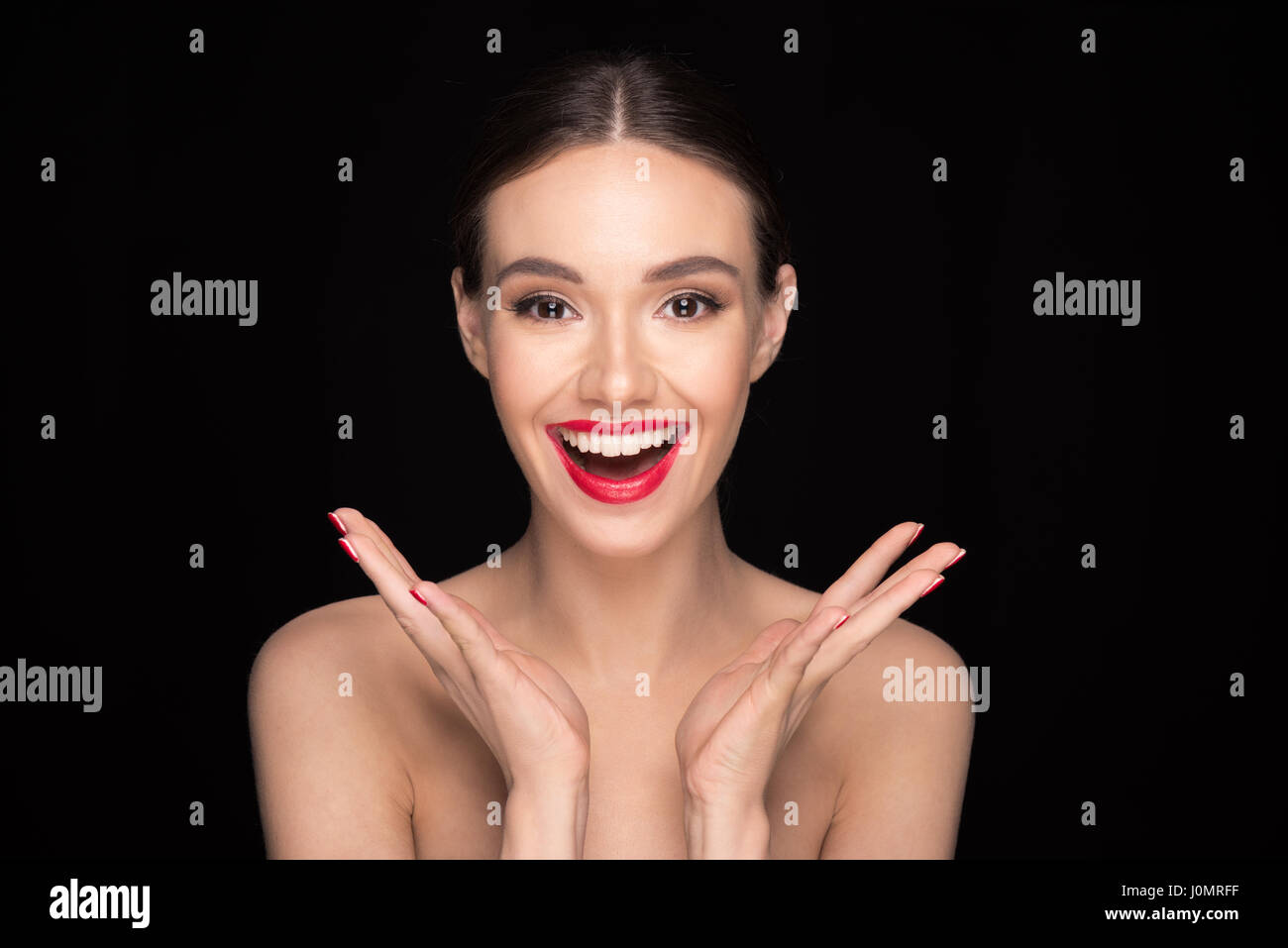 beautiful surprised woman with red lips on black Stock Photo - Alamy