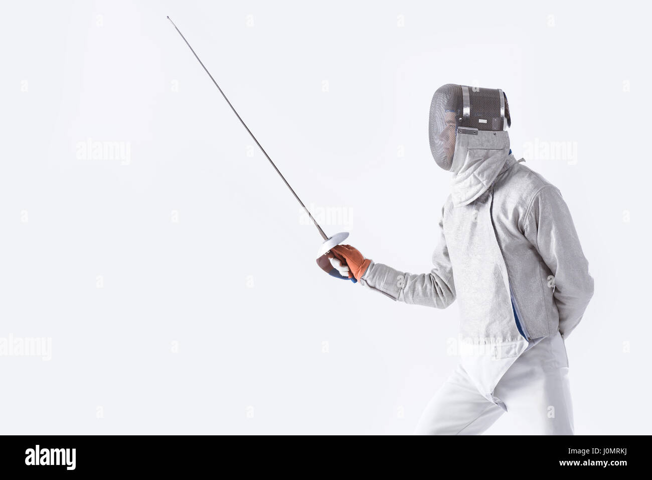 side view of fencer in uniform training with rapier on white Stock ...