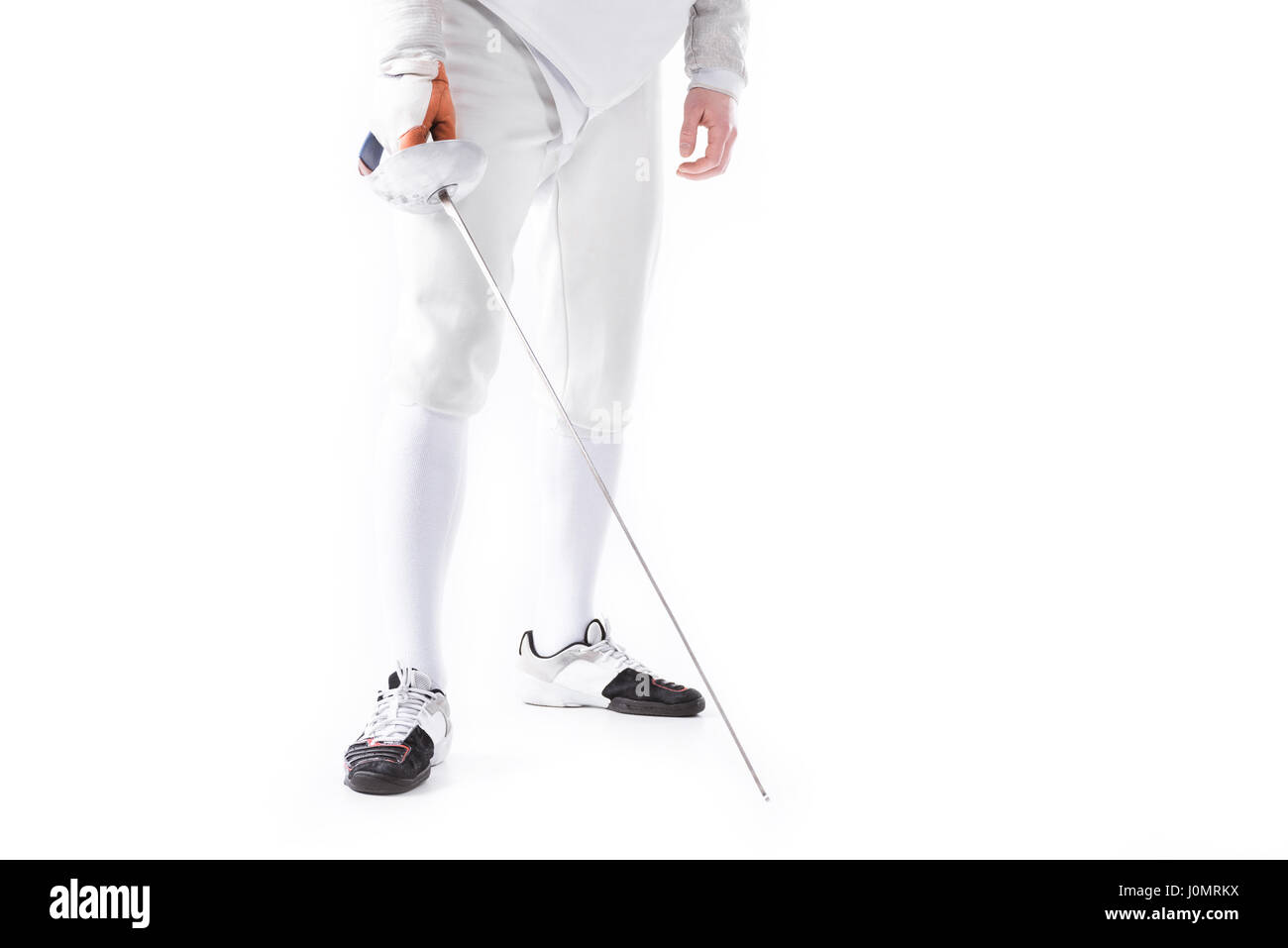 partial view of fencer in uniform holding rapier in hand on white Stock ...