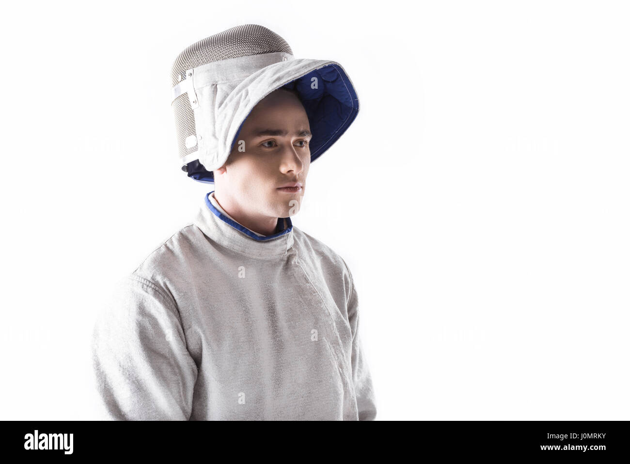 portrait of serious fencer in mask and uniform for training on white ...