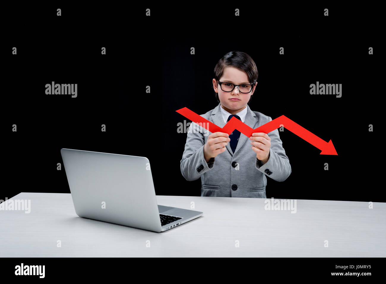 Boy with laptop and arrow at workplace on black Stock Photo - Alamy