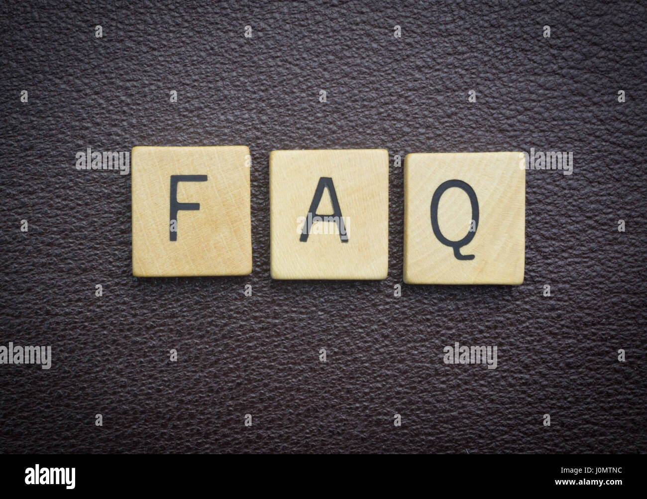 FAQ word concept wood pieces on brown leather Stock Photo - Alamy