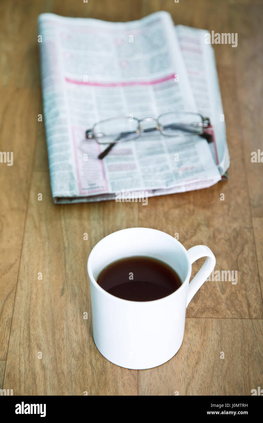 Tea over newspaper Stock Photo - Alamy