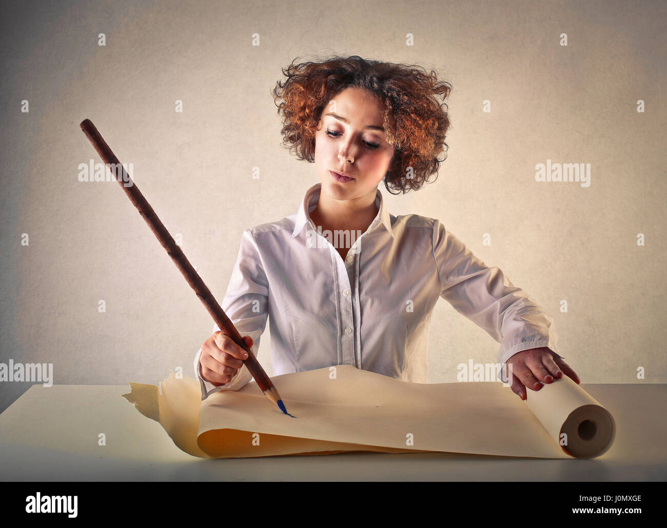 Woman with huge pen and paper Stock Photo - Alamy