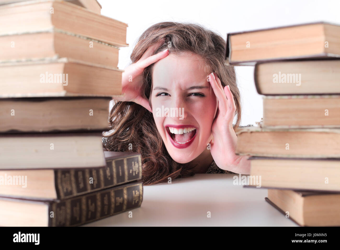 Stressed student woman reading from books Stock Photo - Alamy