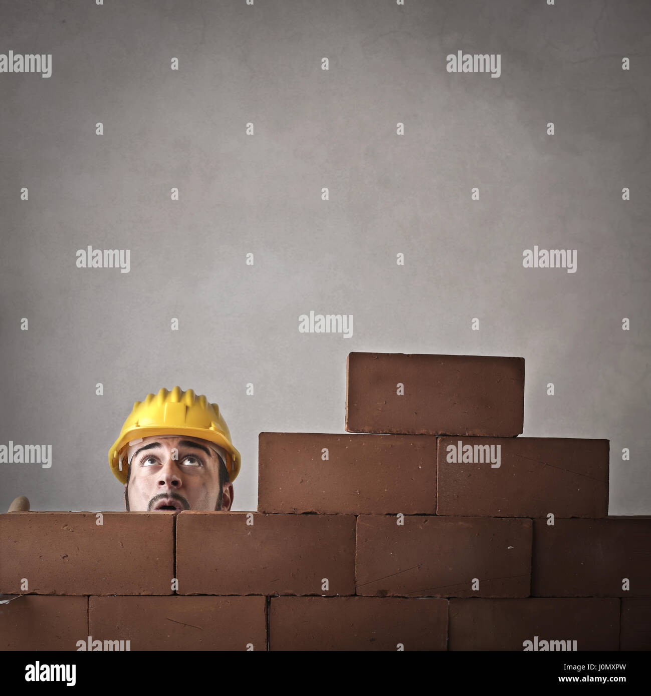 Man hiding behind wall Stock Photo - Alamy
