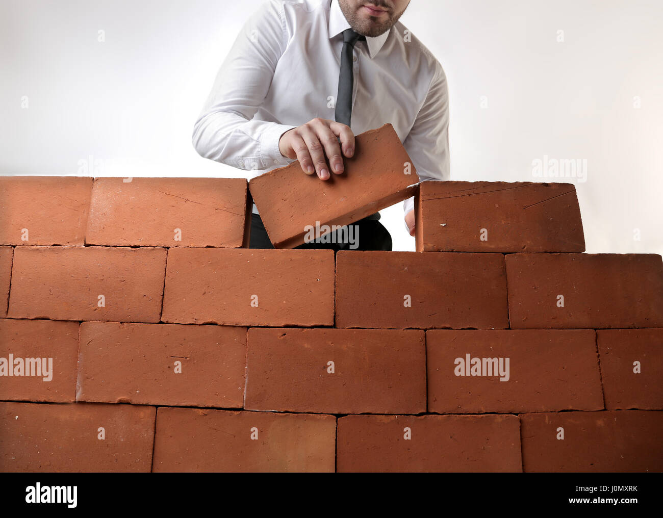 Man building wall Stock Photo - Alamy