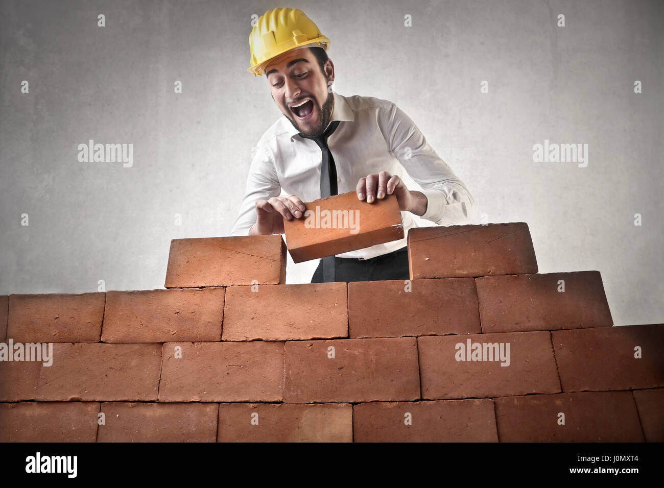 Man building wall Stock Photo - Alamy