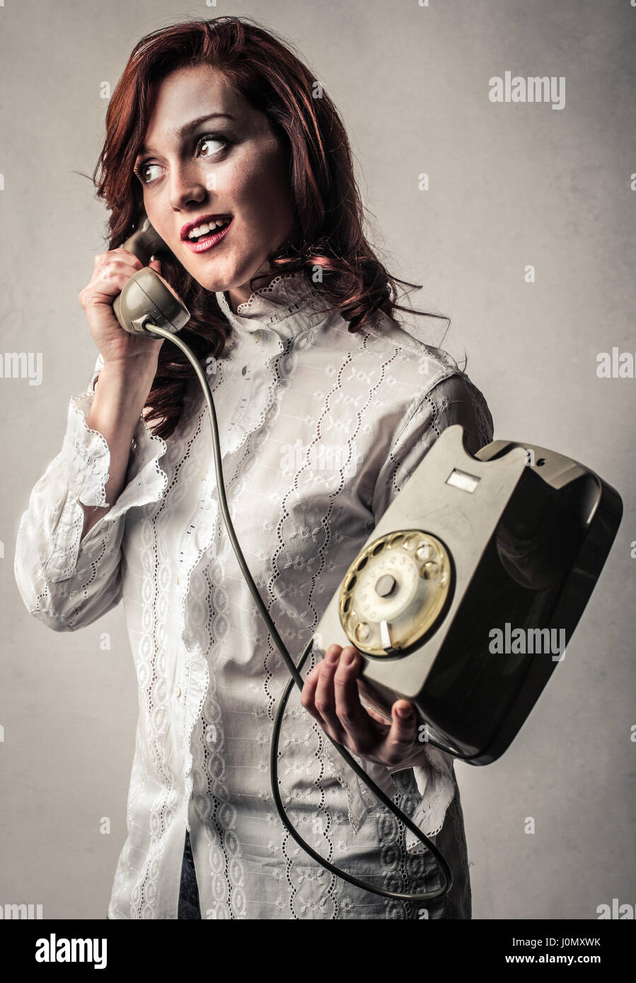 Woman using retro phone Stock Photo - Alamy